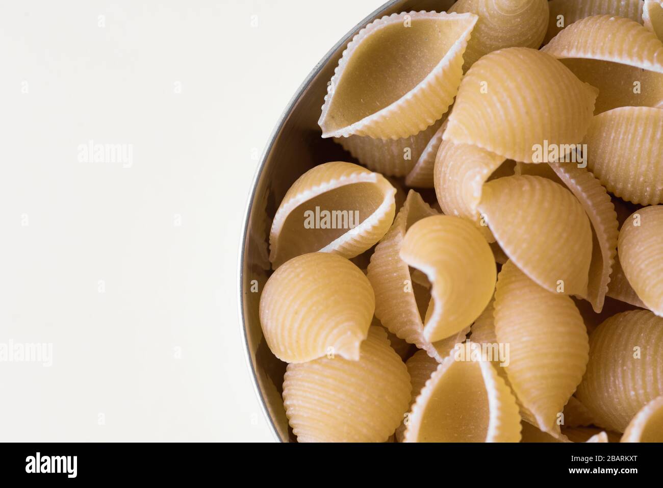 Conchiglie pasta in a bowl isolated macro view on plain background ...