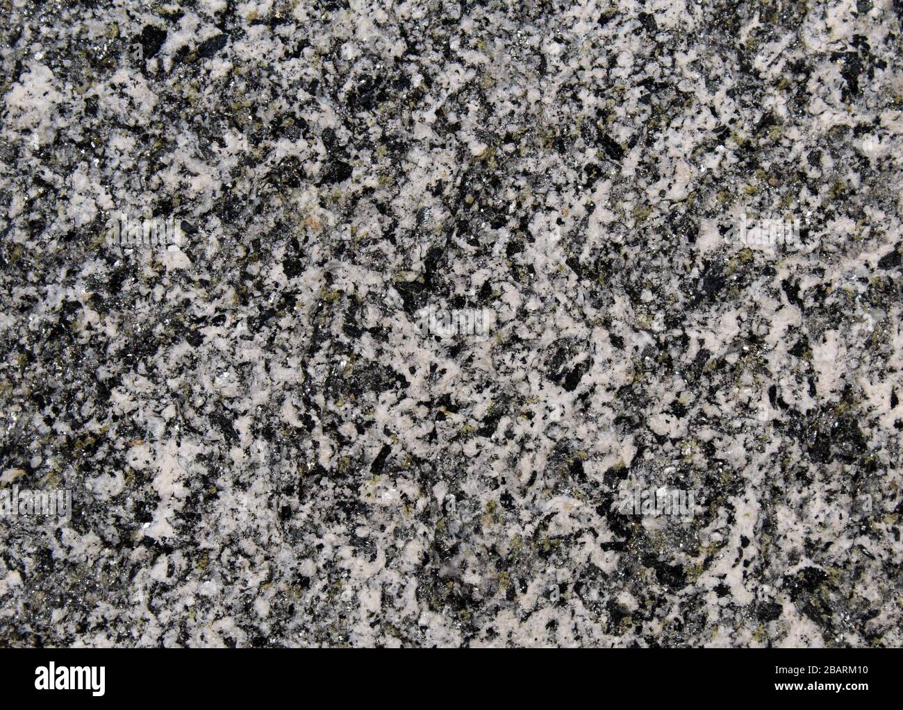 Natural magmatic granite rock dotted grains texture with black and ...