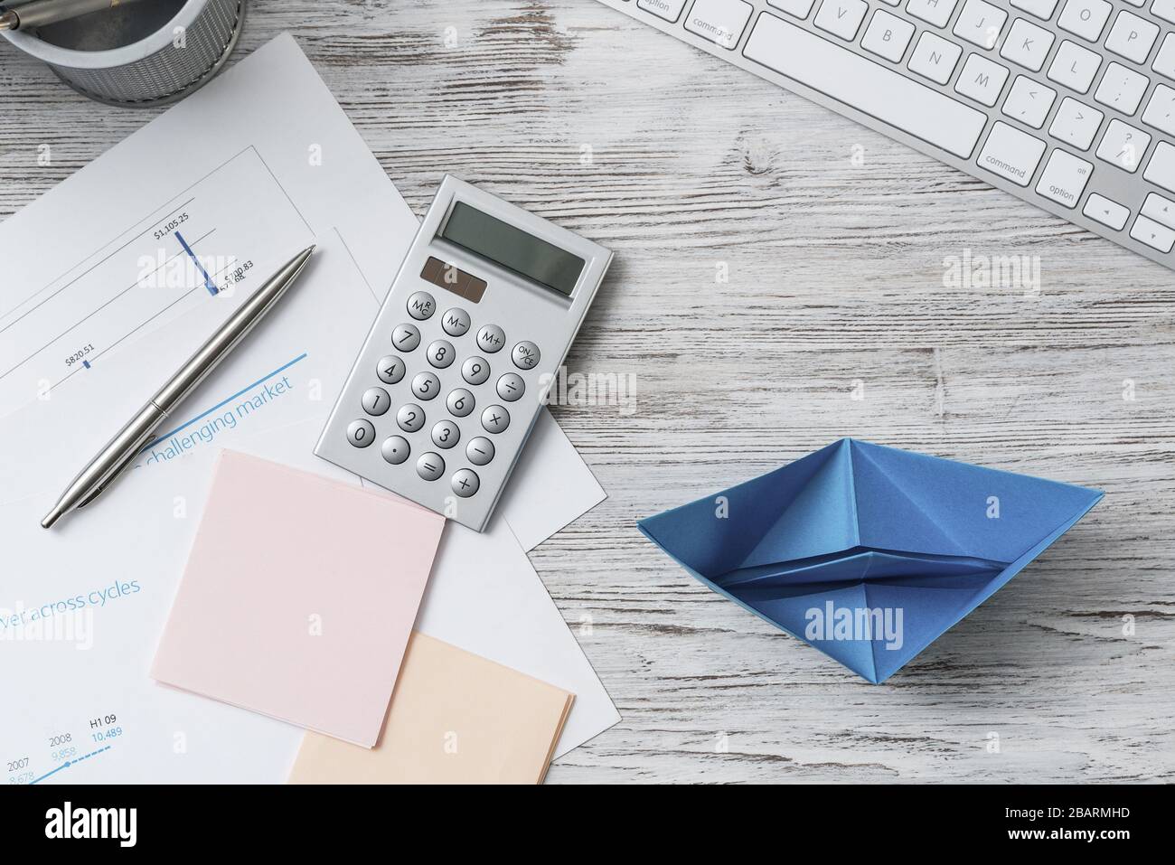 Office workspace with blue paper ship Stock Photo - Alamy