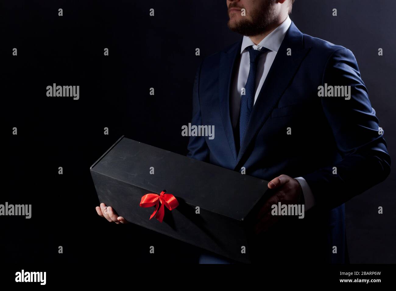 man gives red roses in an original box to his beloved woman Stock Photo ...