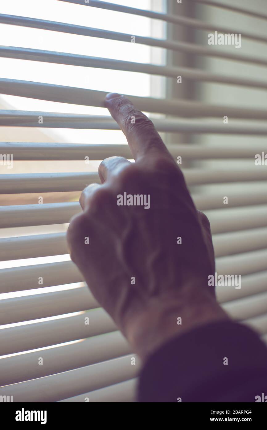 Looking at window with closed blinds hi-res stock photography and ...