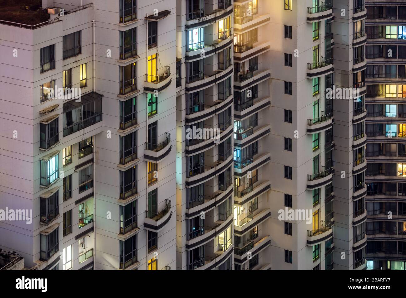 Closeup View of Highrise at Night Time. Colorful Illuminated Windows ...