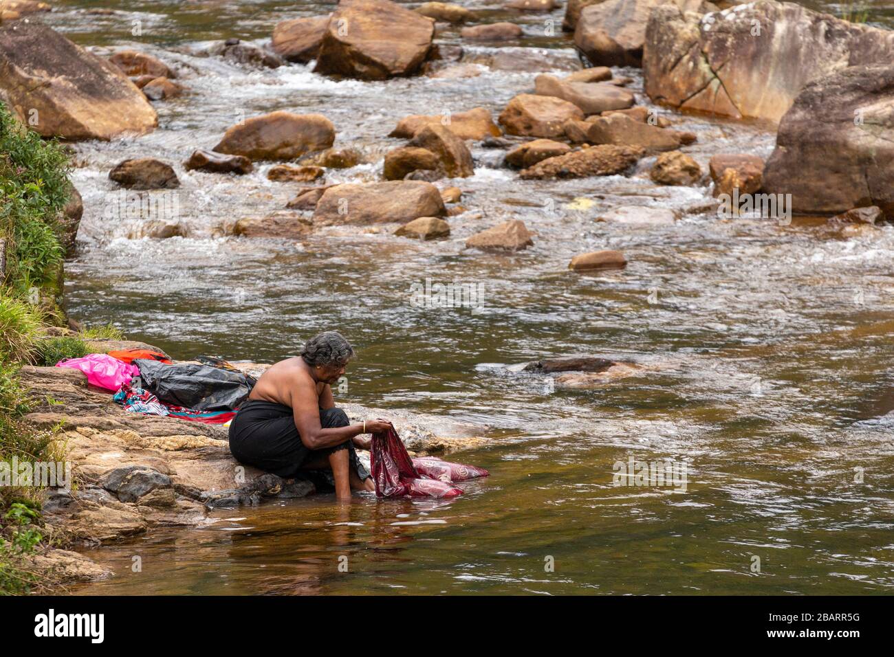 Local woman washing her clothes in the Seetha Gangula river at ...