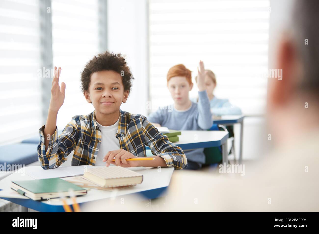 Boy raising arm hi-res stock photography and images - Alamy