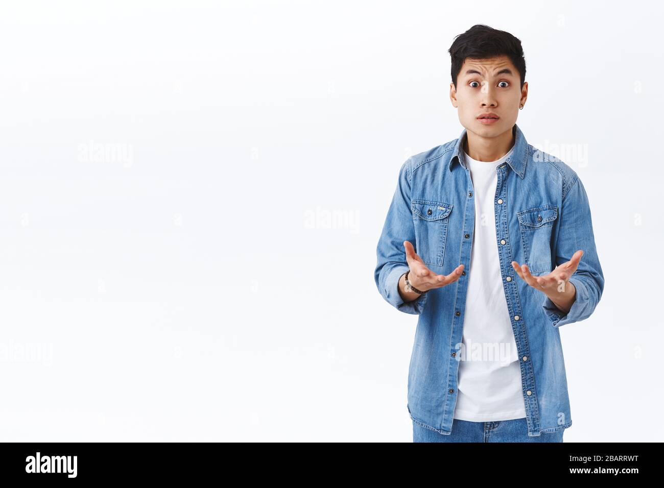 Portrait of concerned intense young alarmed guy, shaking hands and ...