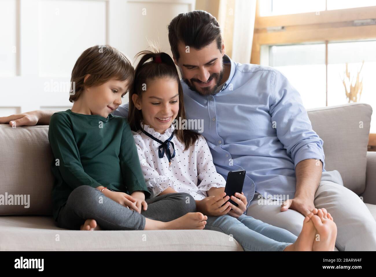 Addicted to tech dad enjoying leisure time with children Stock Photo ...