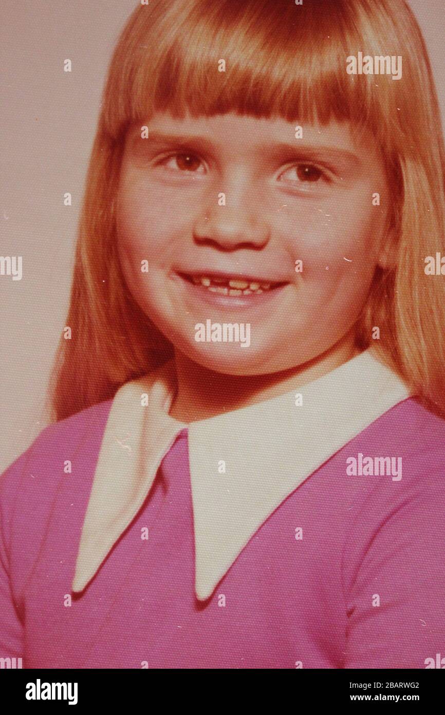Formal grade school portrait of a beautiful young caucasian girl with ...