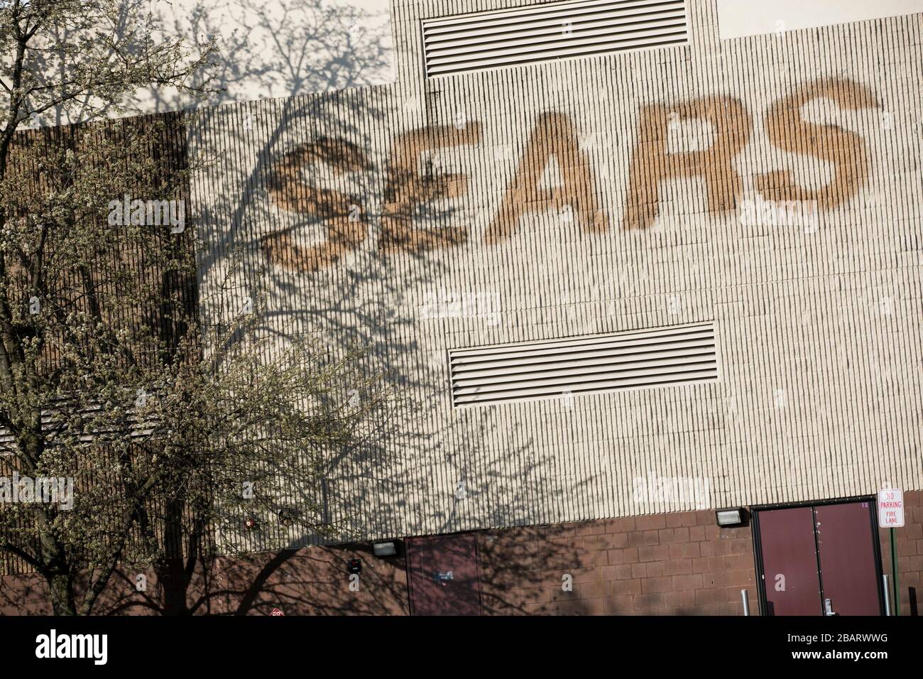 The faded outline of a Sears logo sign outside of a closed and ...
