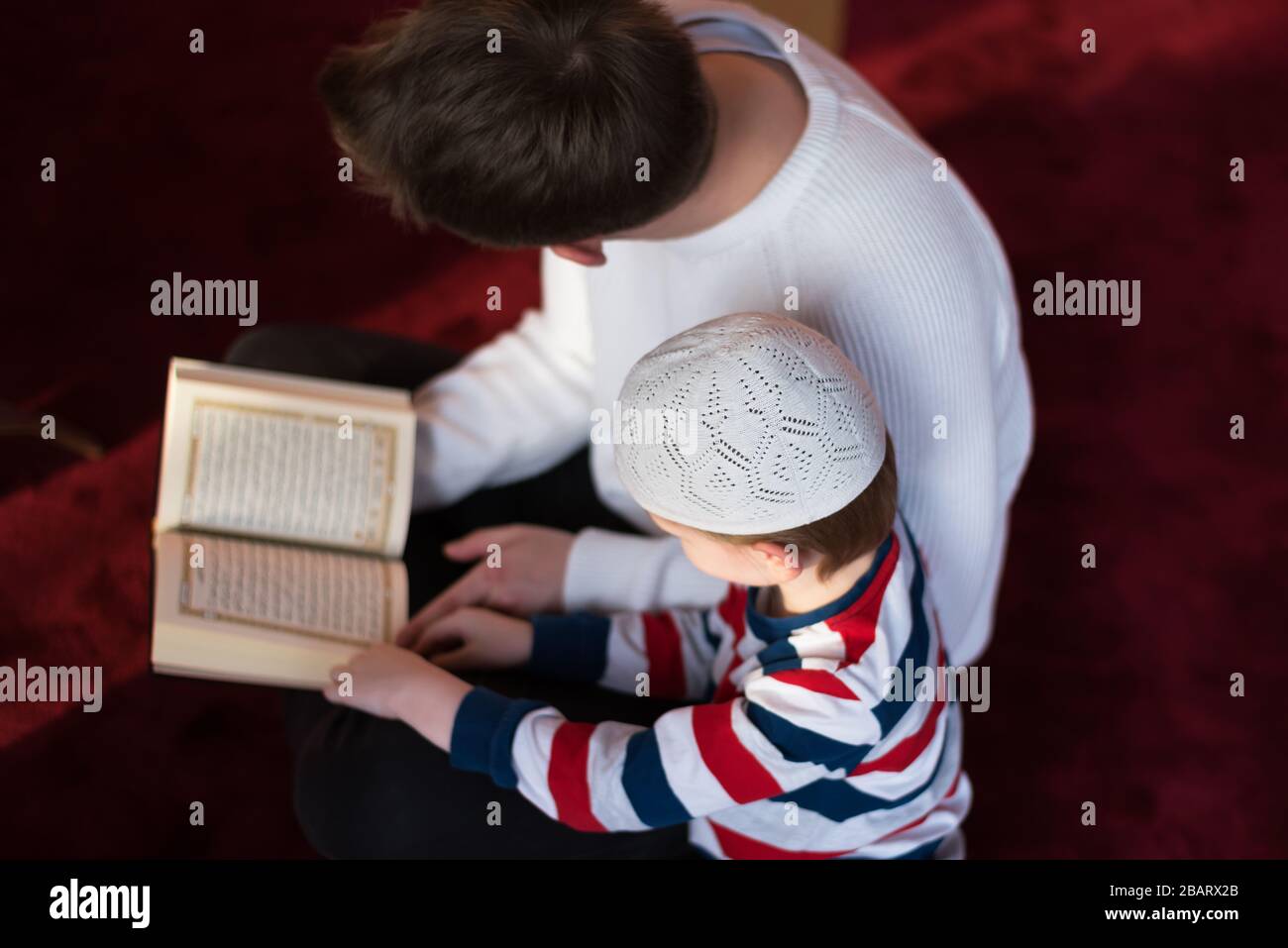 Muslim father and son praying together. Muslim dad and son praying in ...