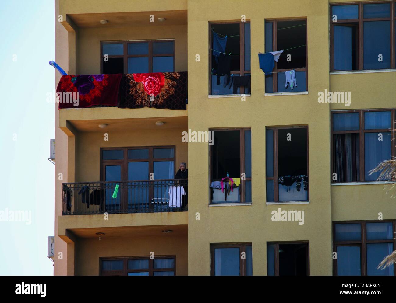 Gaza, Palestine. 29th Mar, 2020. A Palestinian man looks from a balcony ...