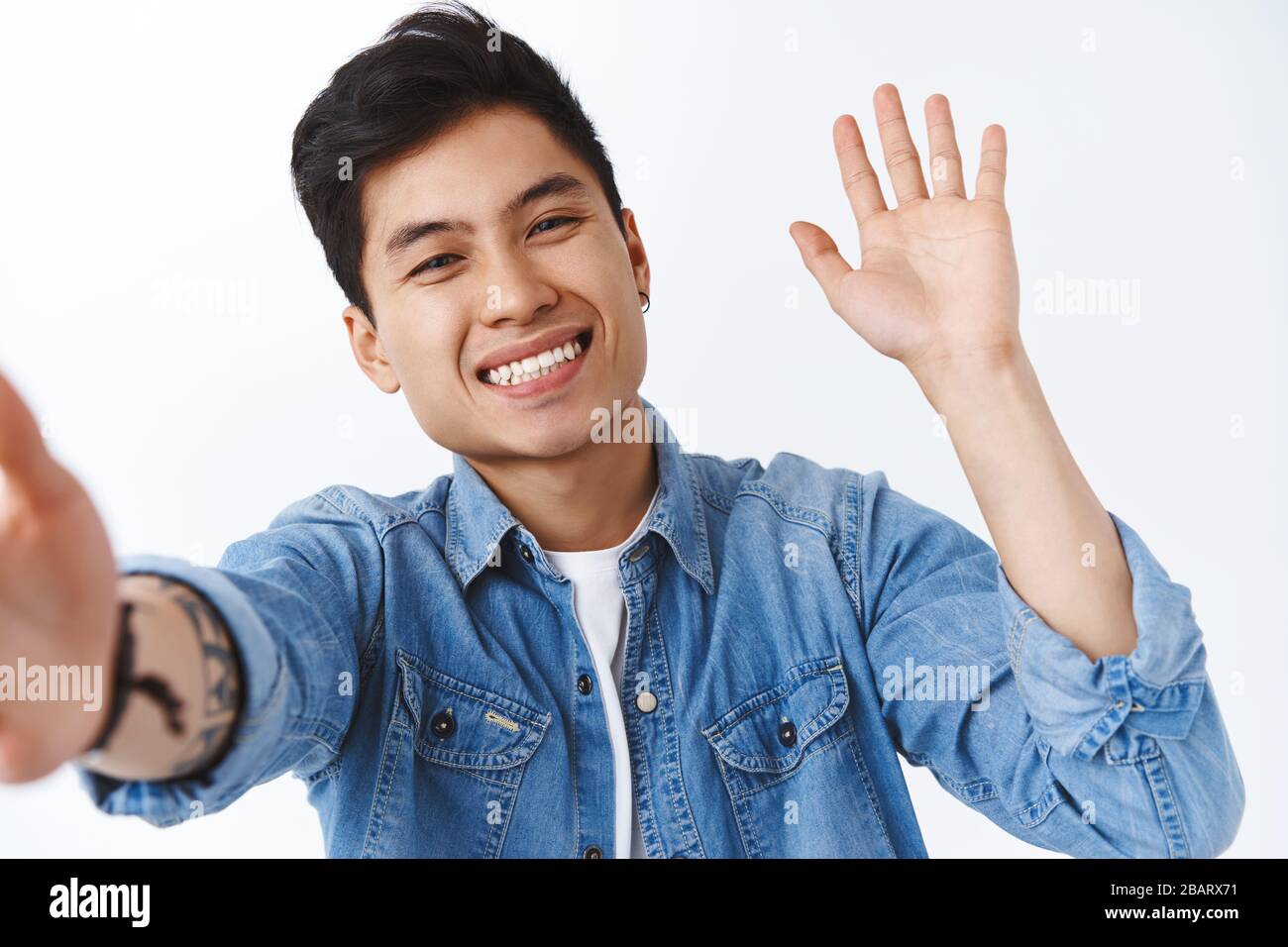 Happy charismatic asian man taking selfie on smartphone, calling ...