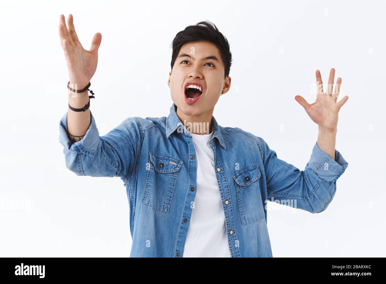 Feeling might and power. Portrait of passionate, excited asian man ...