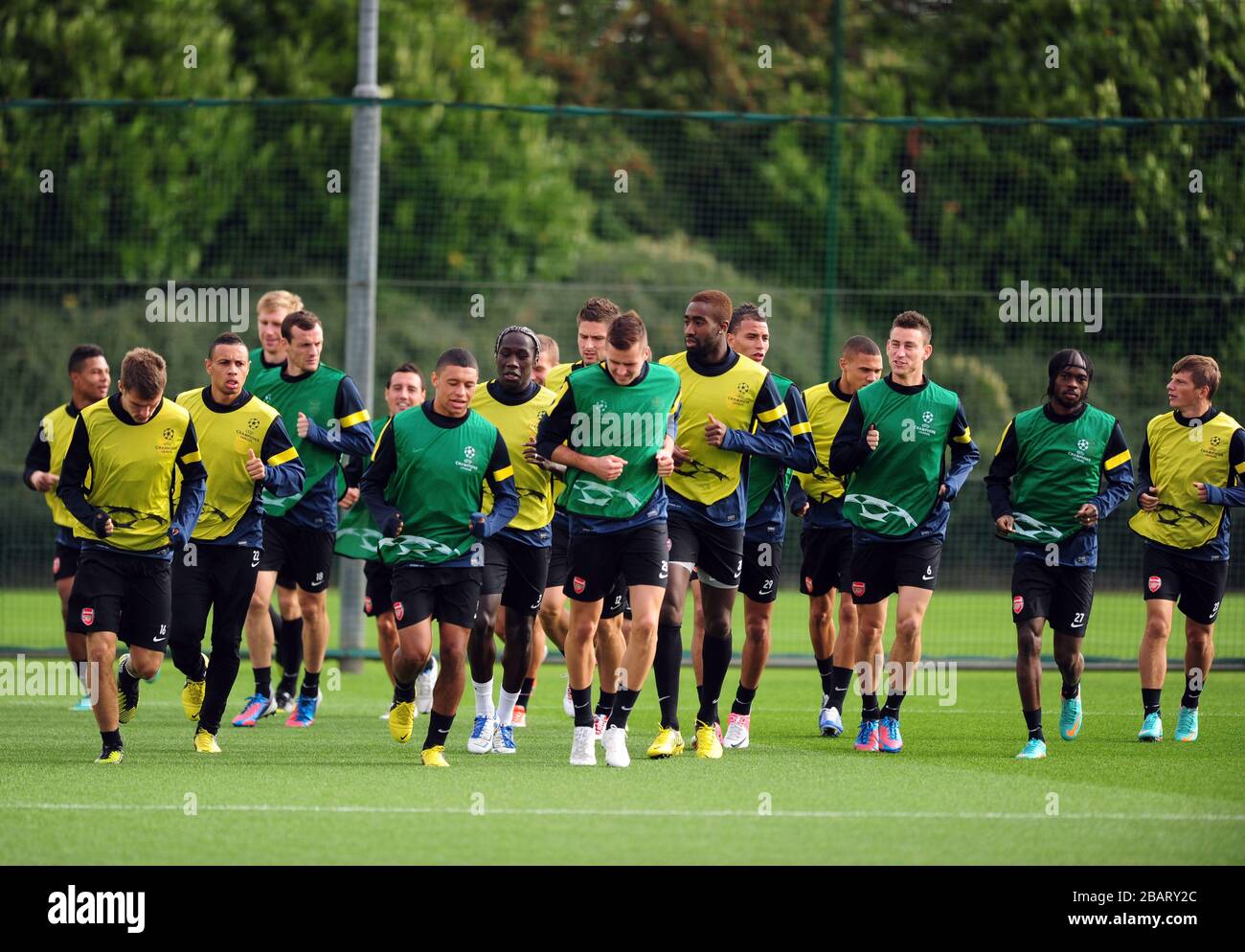 Arsenal players warm up before training Stock Photo - Alamy
