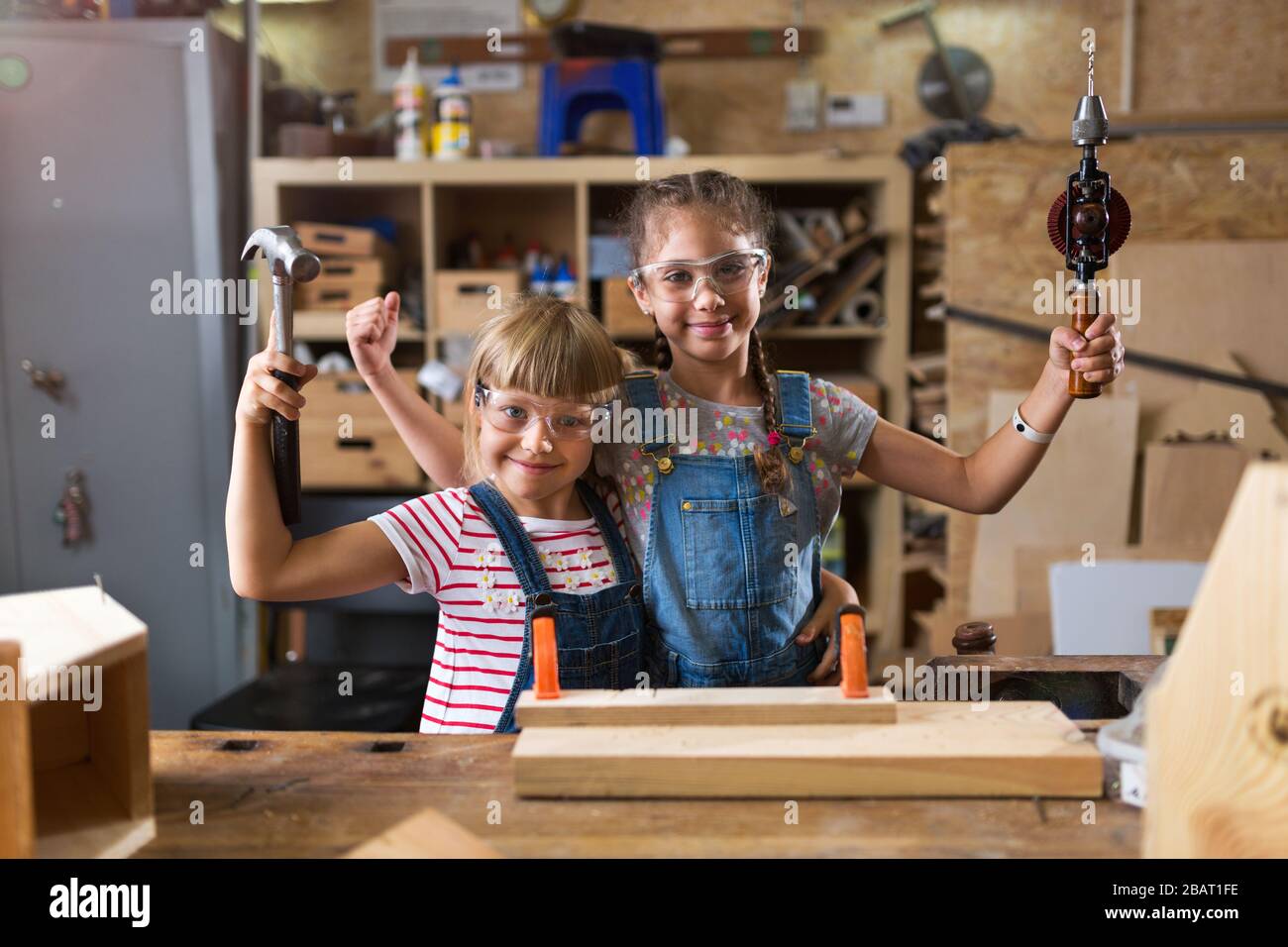 Two young girls doing woodwork in a workshop Stock Photo - Alamy