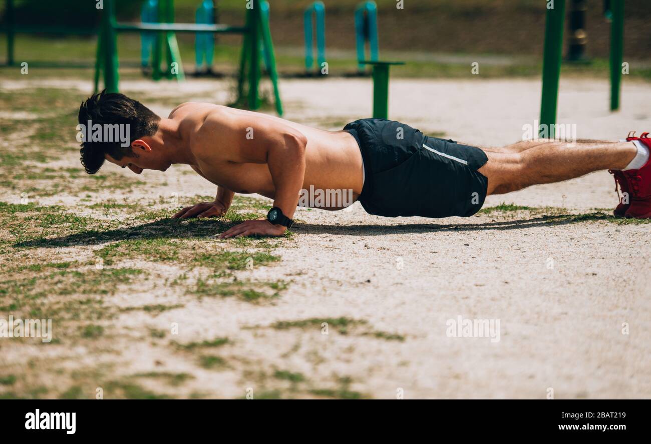 Active man doing planking core muscles exercise outdoors Stock Photo ...