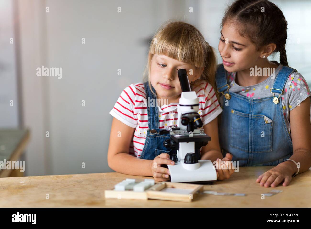 Girls with microscope Stock Photo - Alamy
