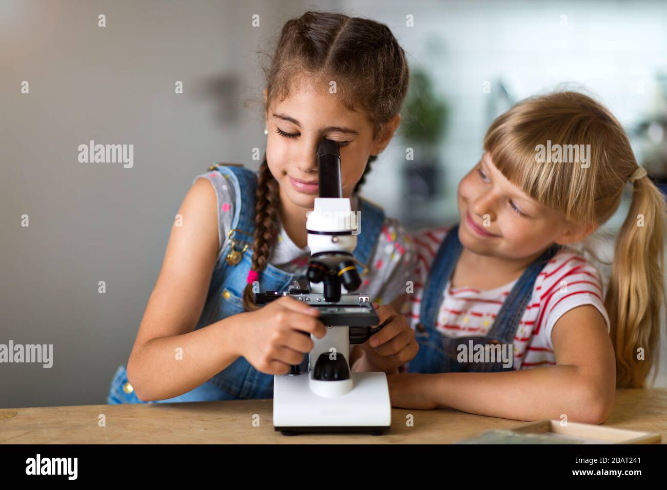 Girls with microscope Stock Photo - Alamy