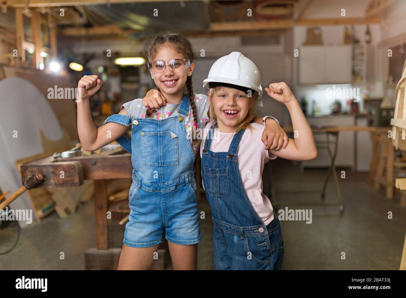 Two young girls doing woodwork in a workshop Stock Photo - Alamy
