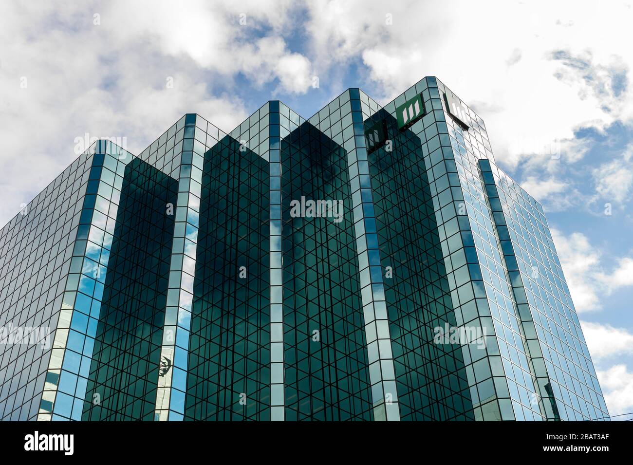 Low angle view of modern contemporary glass building against blue sky ...