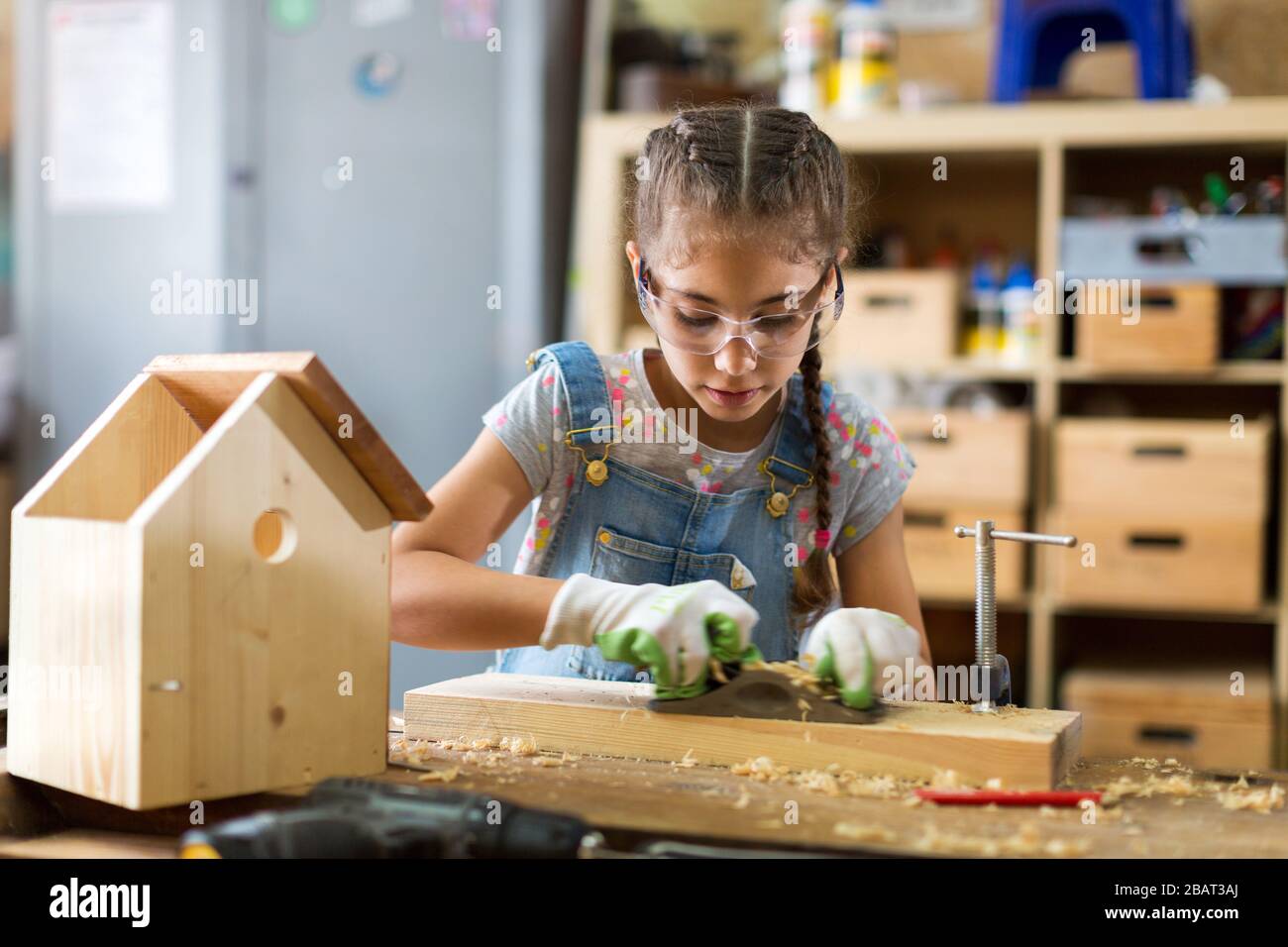 Two young girls doing woodwork in a workshop Stock Photo - Alamy