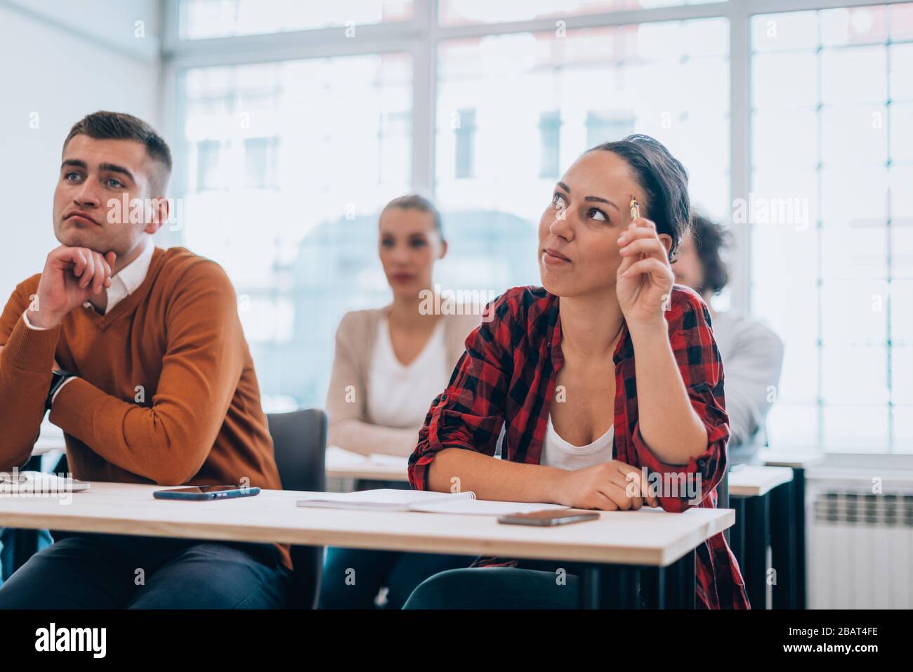 Group of coworkers having a business plan discussion at their office ...
