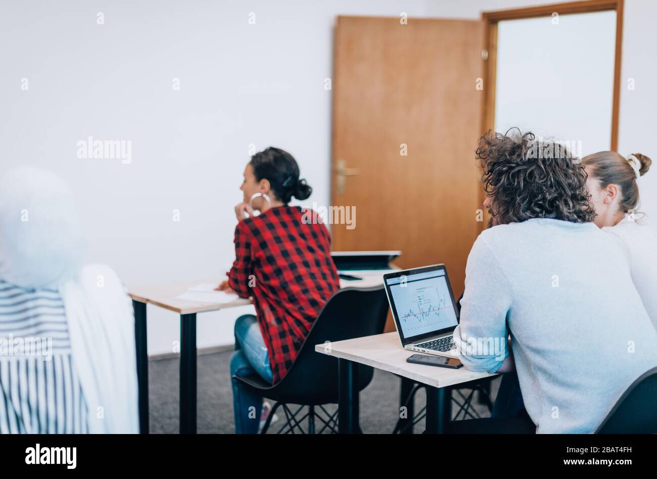 Group of coworkers having a business plan discussion at their office ...