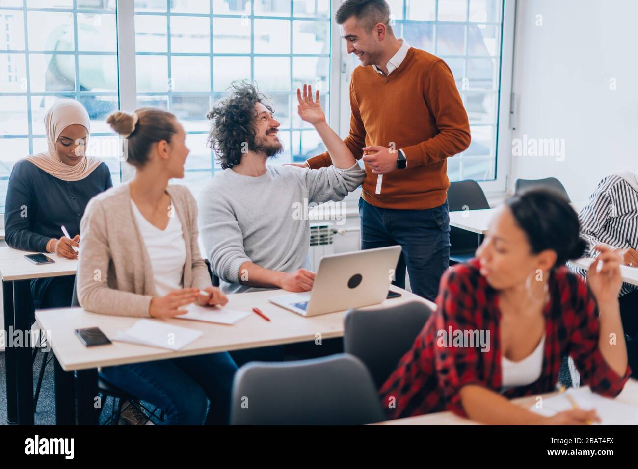 Group of work colleagues talking about the business plan at the office ...