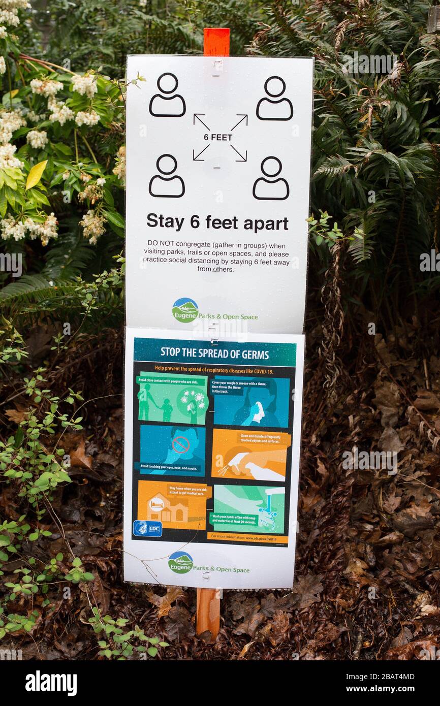 A sign alerting people to stay 6 feet apart due to the Covid 19 virus ...