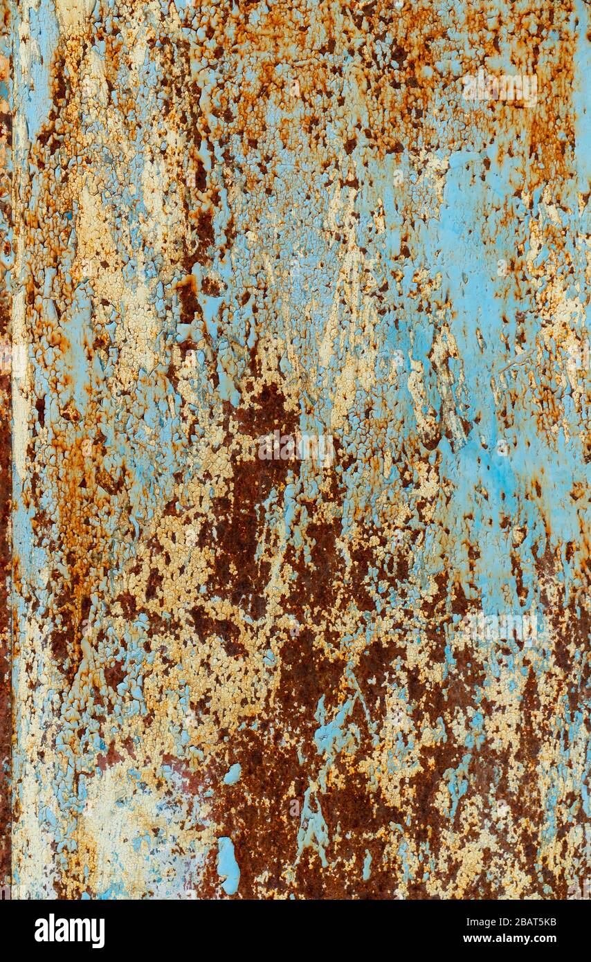 rust and damaged blue and yellow paint on metal sheet. Backgrounds and ...