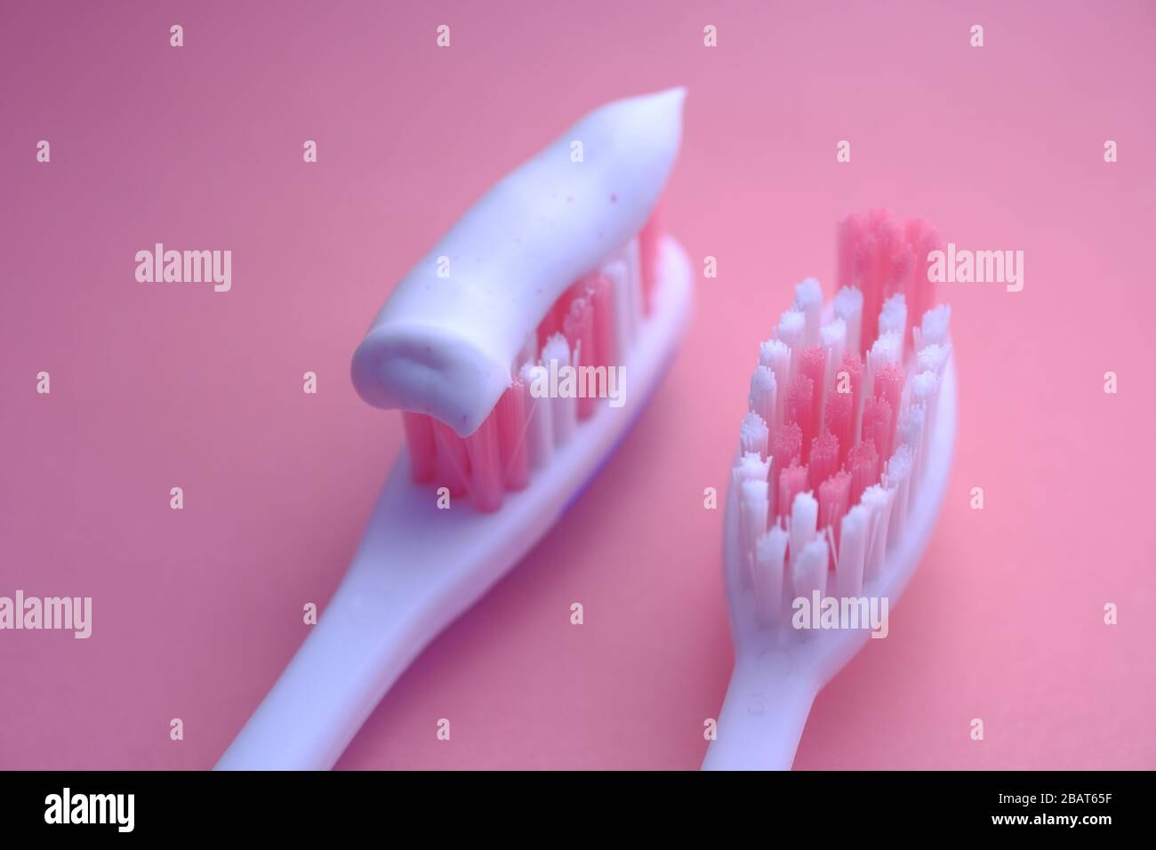 pink color toothbrush on color background Stock Photo - Alamy