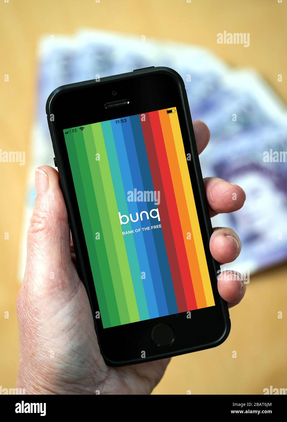A woman using the bunq bank app on a mobile phone. (Editorial Use Only ...