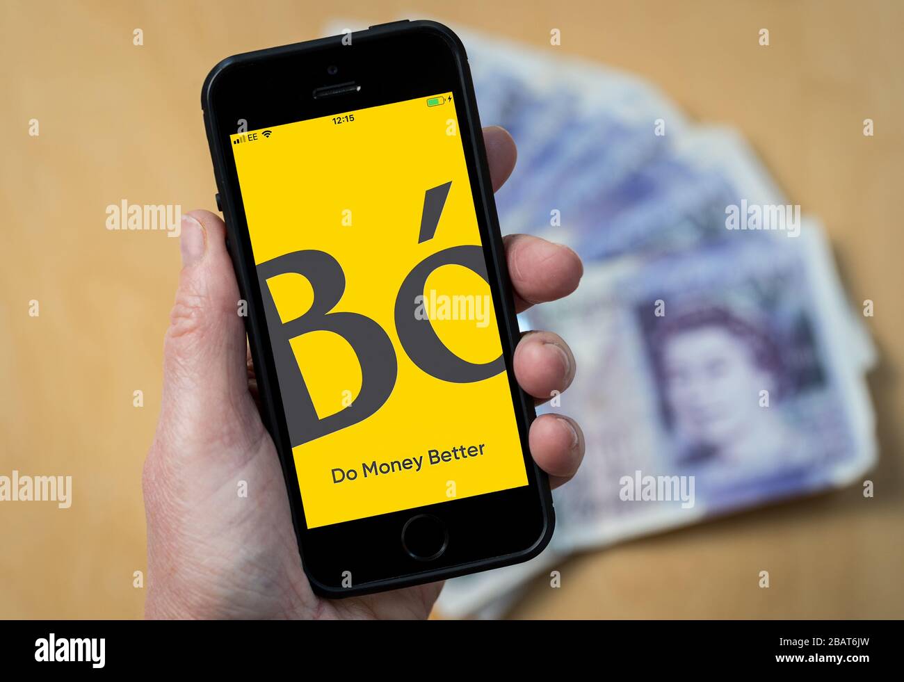 A woman using the Bo banking app on a mobile phone. (Editorial Use Only ...