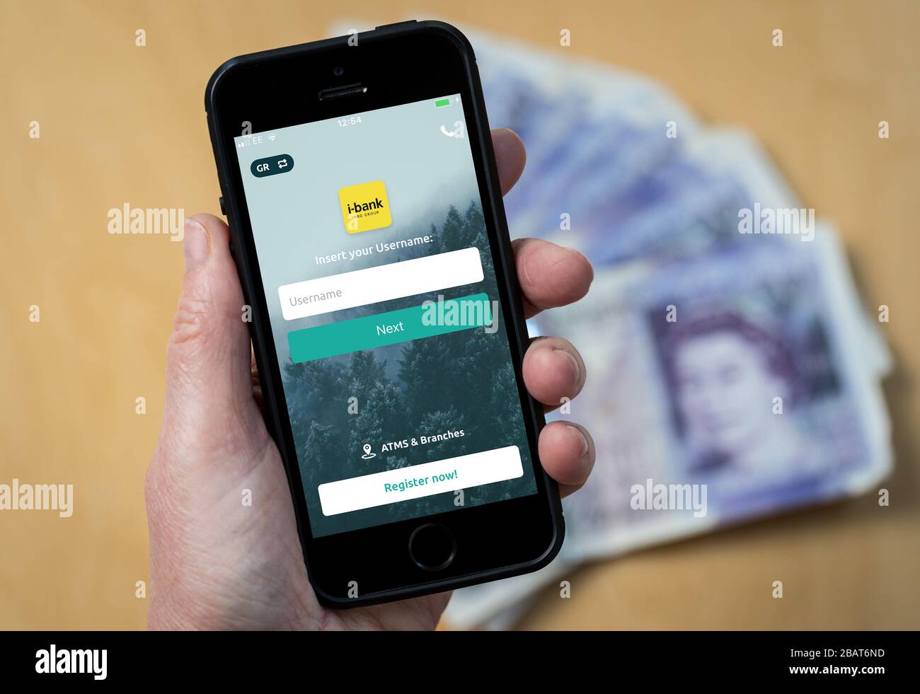 A woman using the NBG i-bank app on a mobile phone. (Editorial Use Only ...