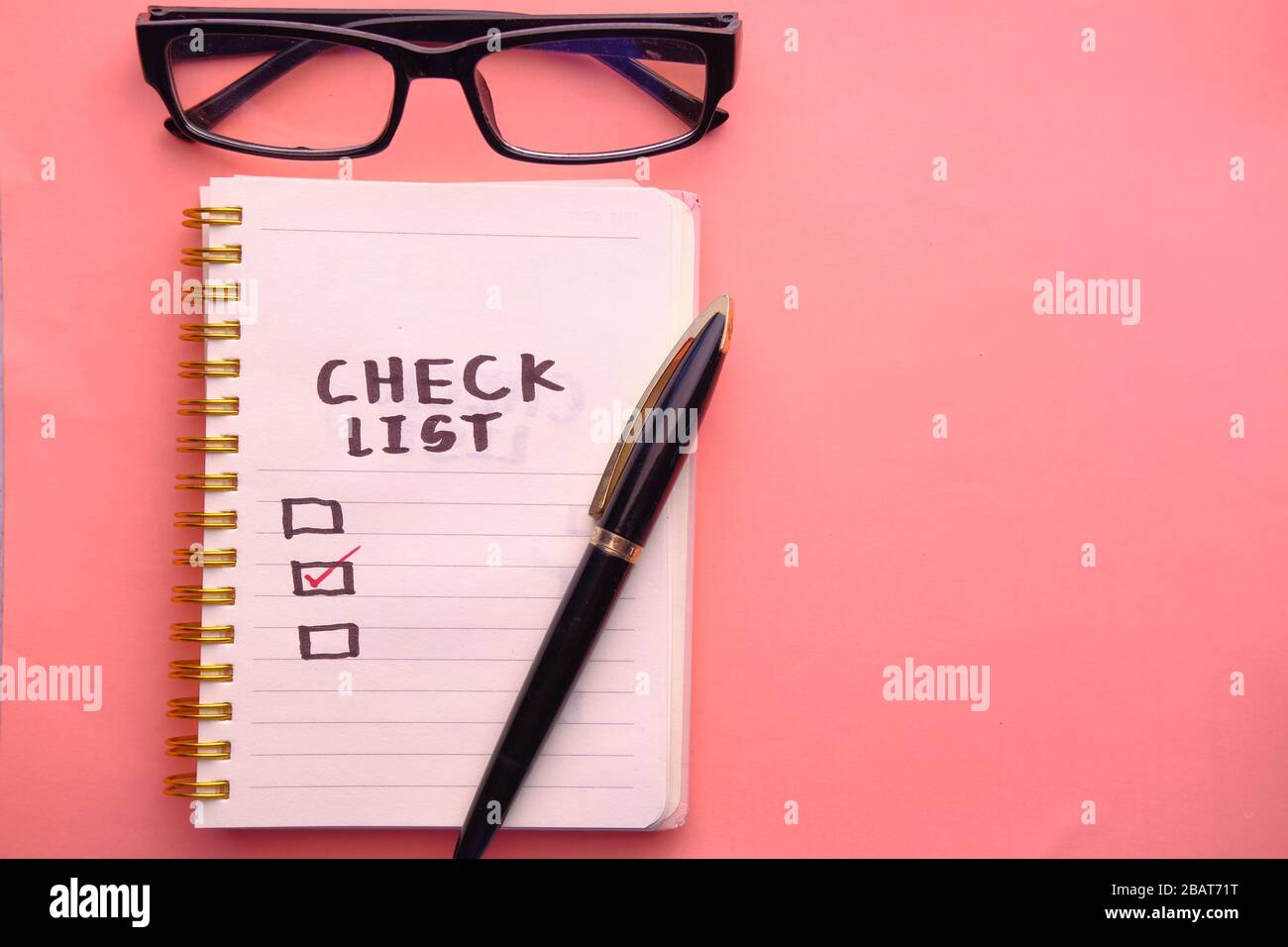 top view of check mark on notepad on color background Stock Photo - Alamy