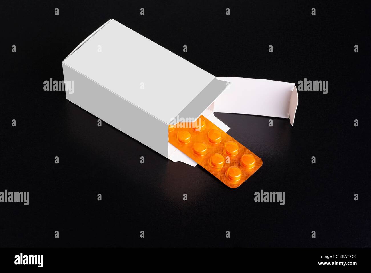 Single loaf of tablet getting out form the blank box on black ...