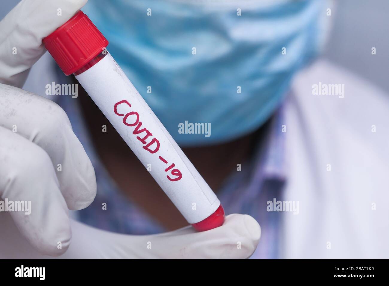 Male chemist hand hold test tube closeup background Stock Photo - Alamy