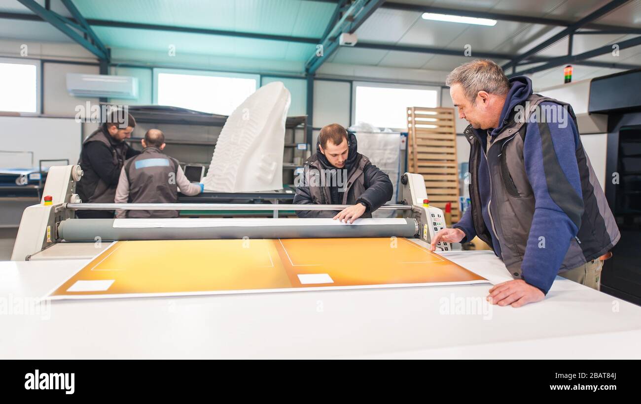 Large group of worker printmaker technician operator works in digital ...