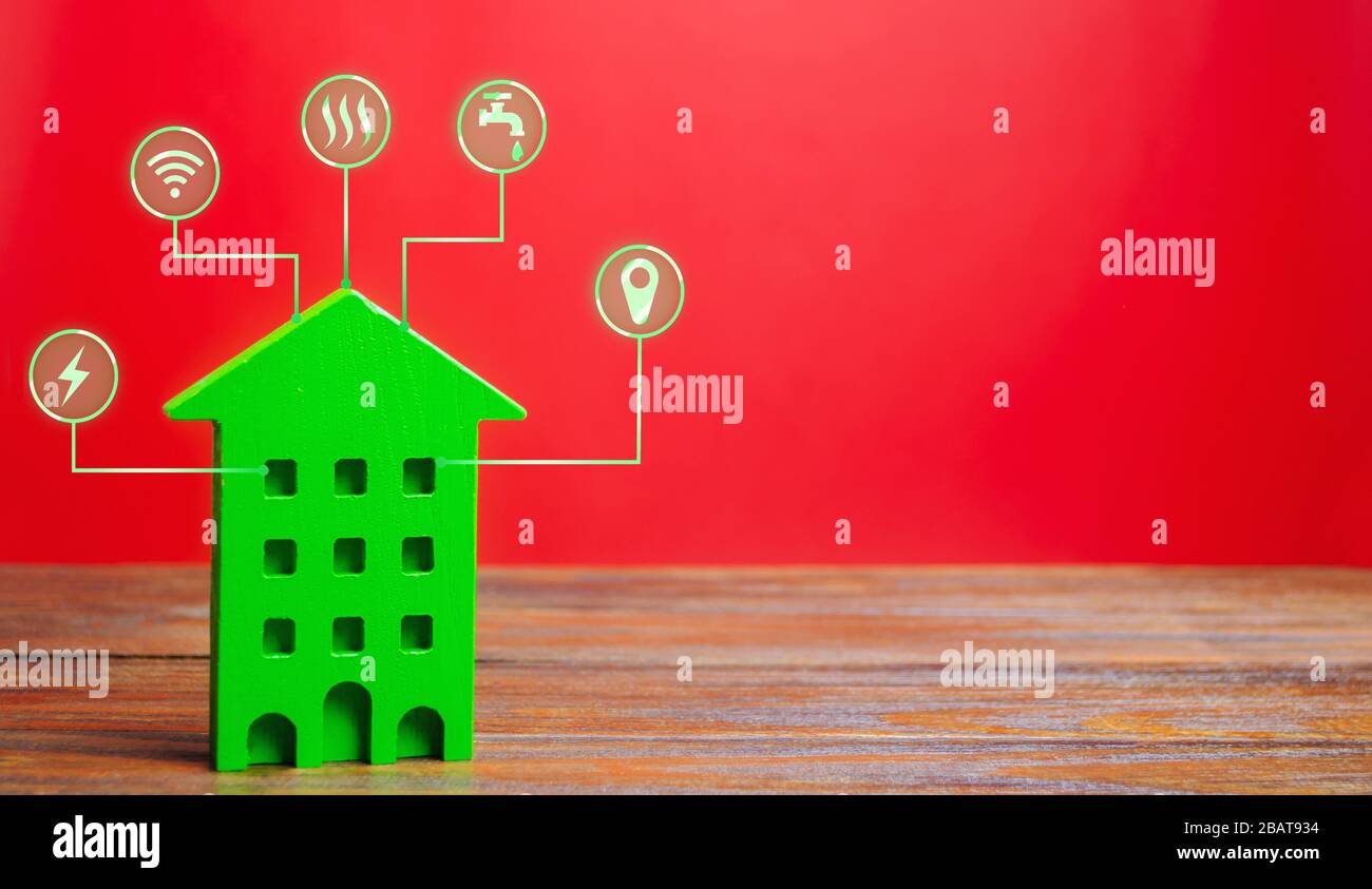 Miniature wooden house and symbols of public utilities. Choosing a ...