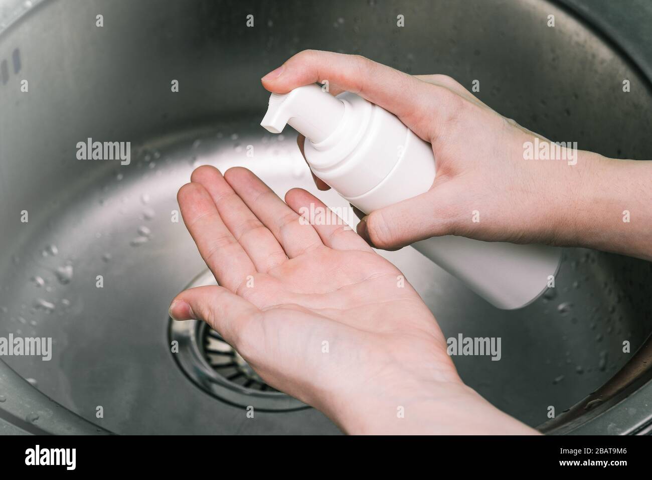 Girl holds a white sanitary container in her hand. Detergent for ...