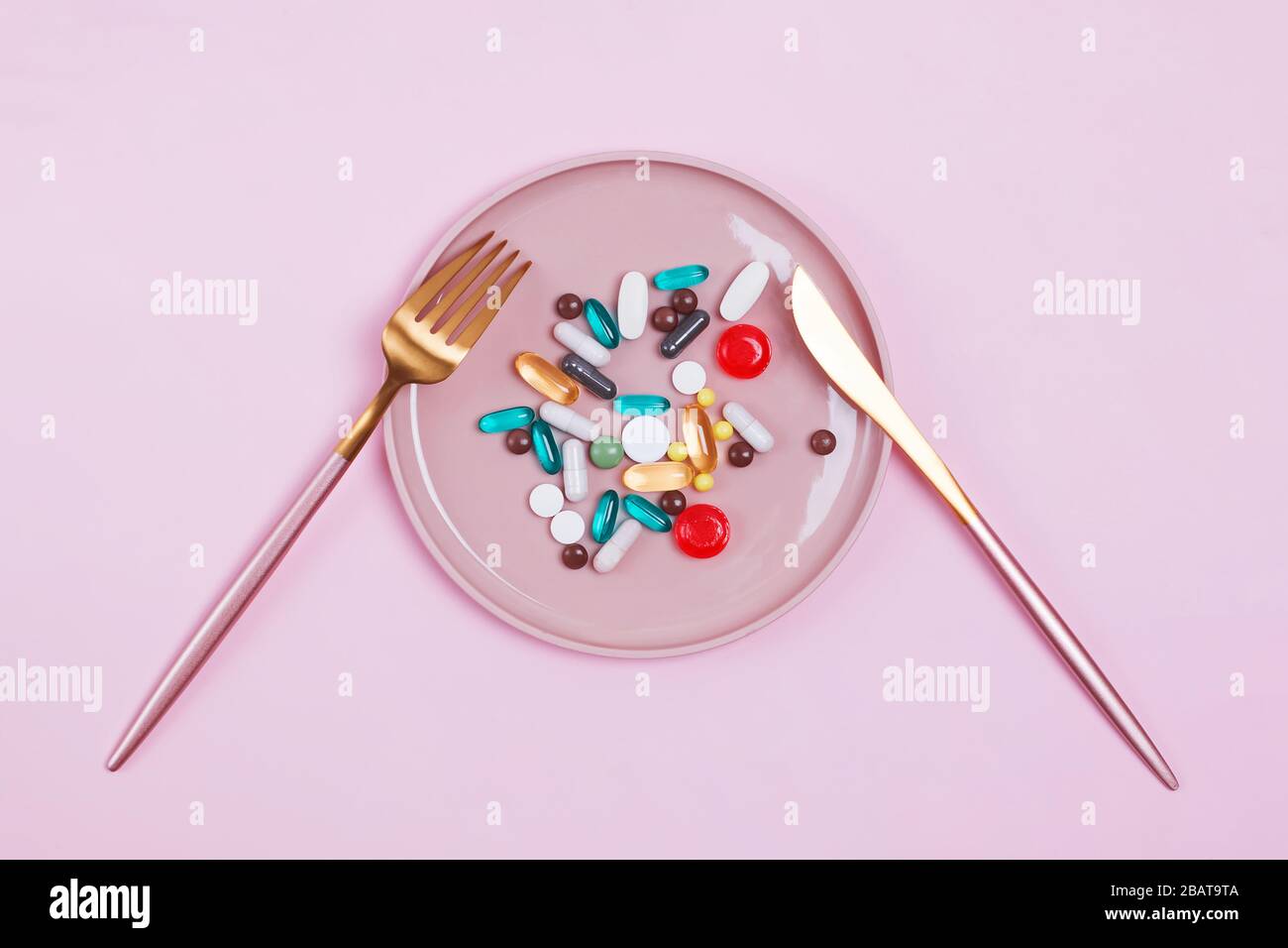 A plate full of capsules and tablets of different shapes and sizes with ...