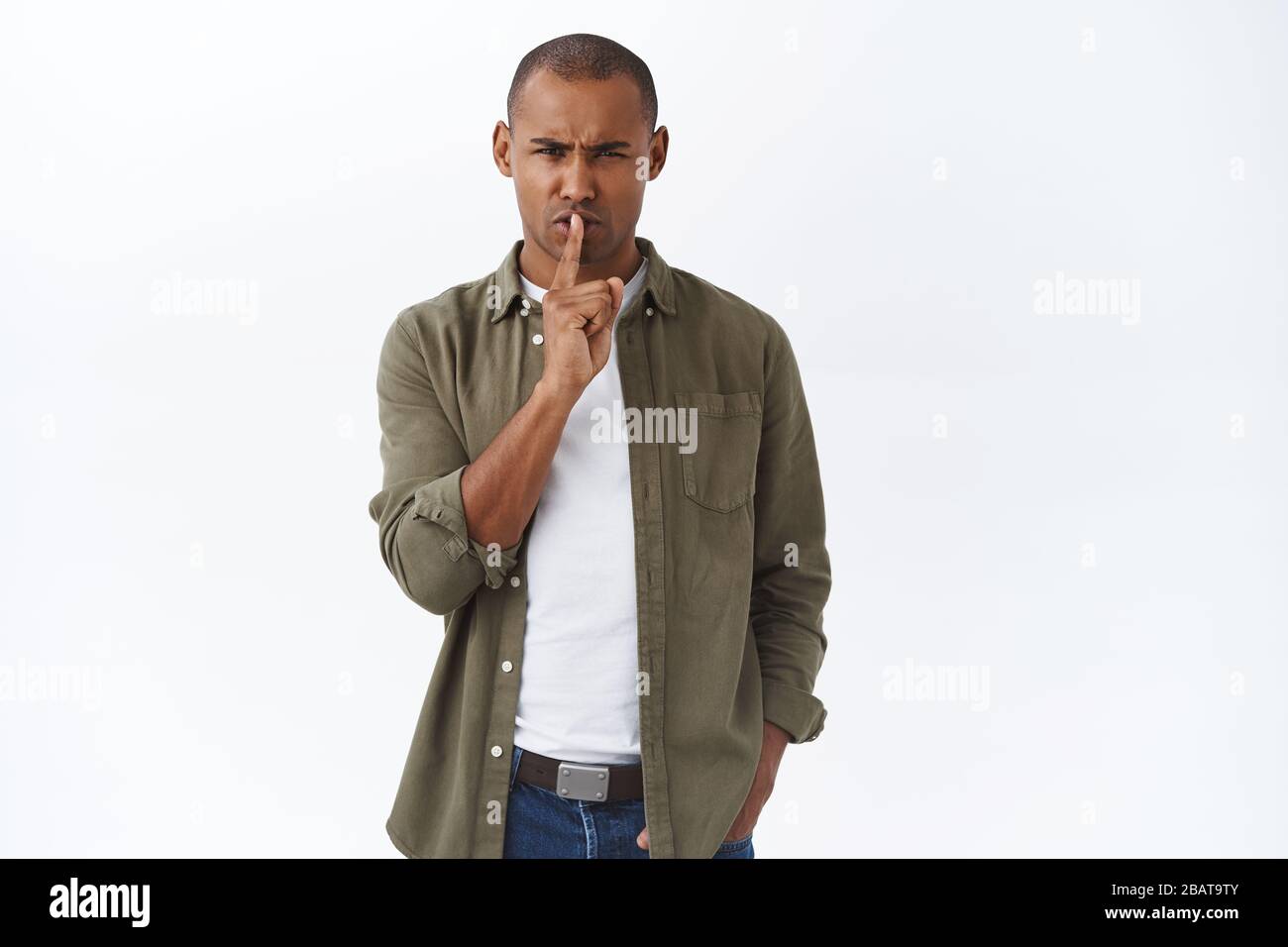 Portrait of angry, displeased african-american man shushing with ...