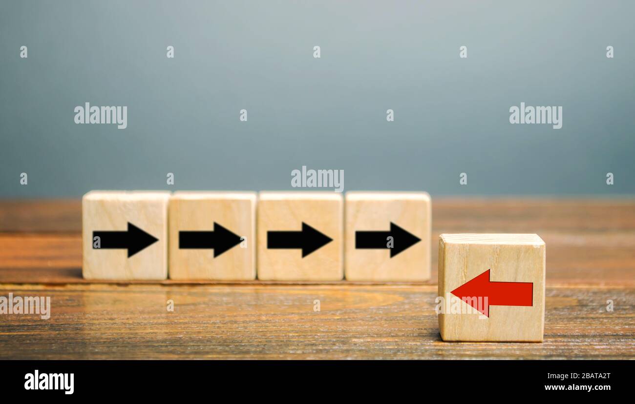 Wooden blocks with arrows. Individual opinion concept. Stand out from ...