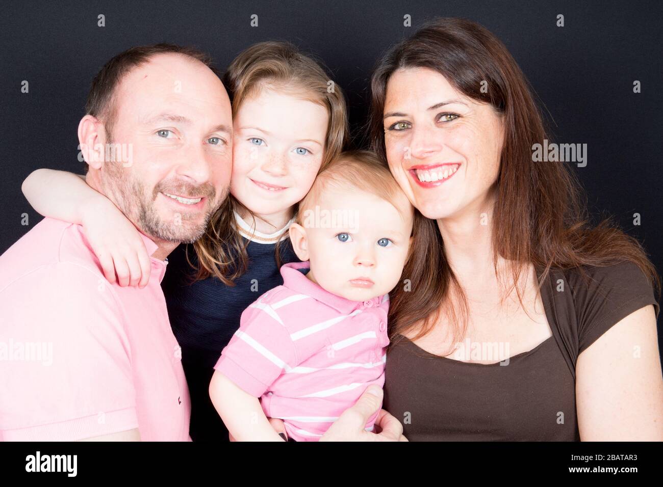 Portrait Of Happy Family In black background father mother son and ...