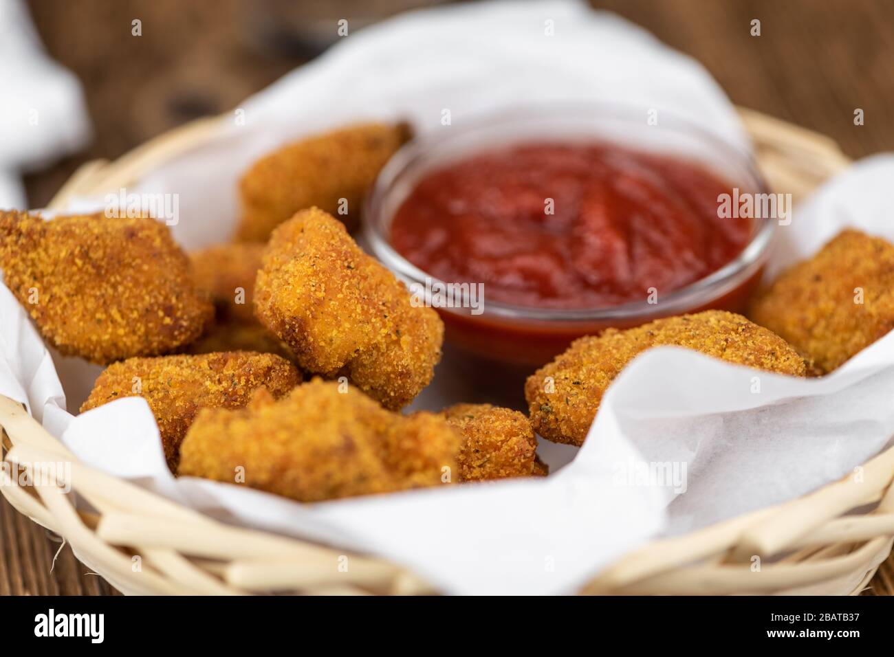 Vintage wooden table with fresh made Chicken Nuggets (close-up shot ...
