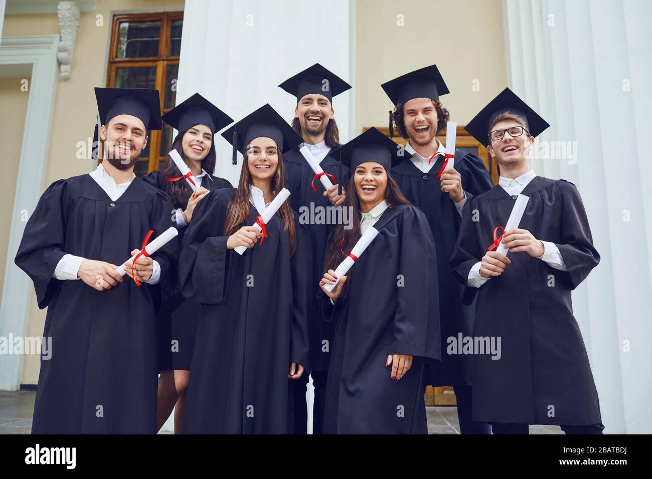 A group of graduates smiling Stock Photo - Alamy
