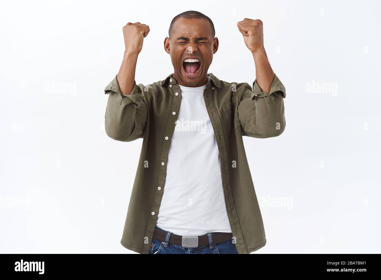 We are champions. Portrait of triumphing african-american man ...