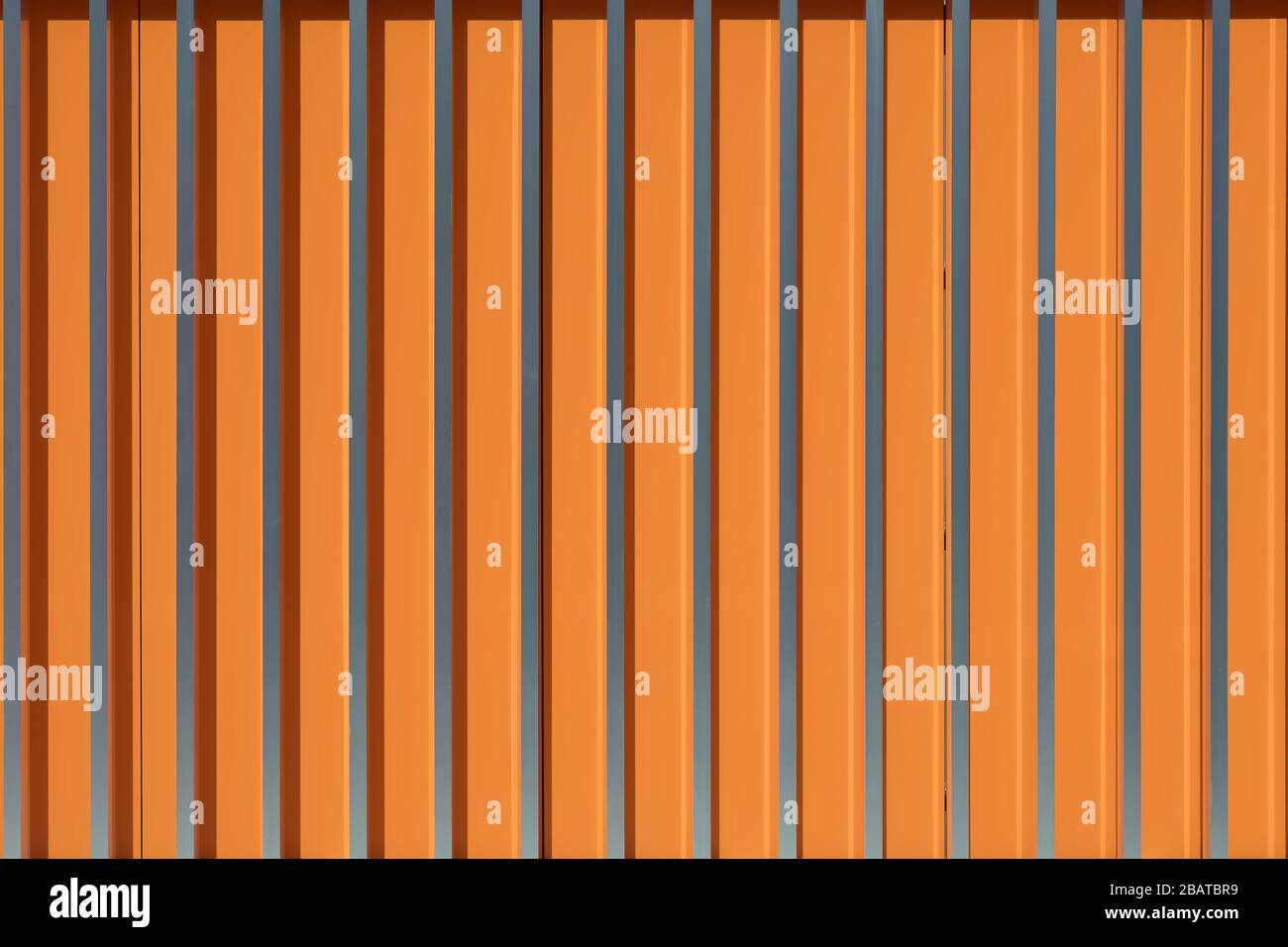 Building with wall of orange metal Stock Photo - Alamy