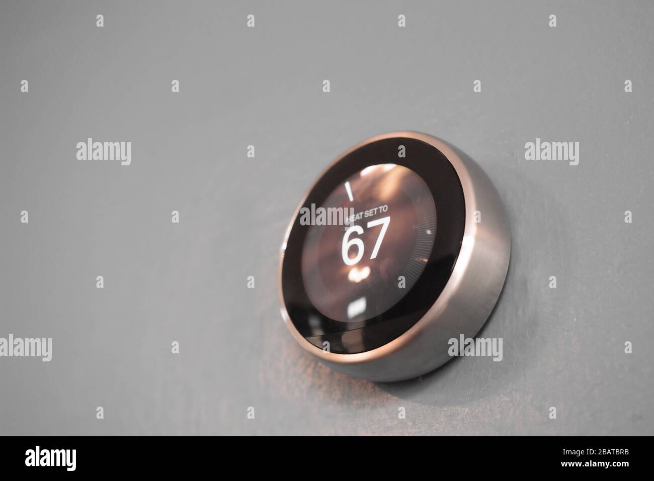 Smart home thermostat with red center in heat mode. Saving energy ...