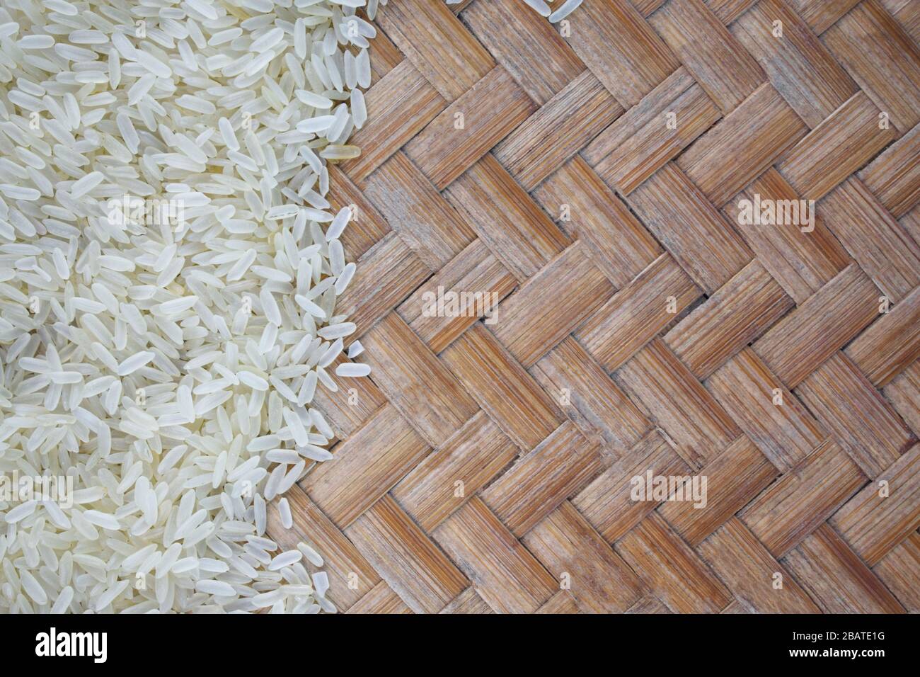 Rice grains held in a designed wooden carpet where the rice grains are ...