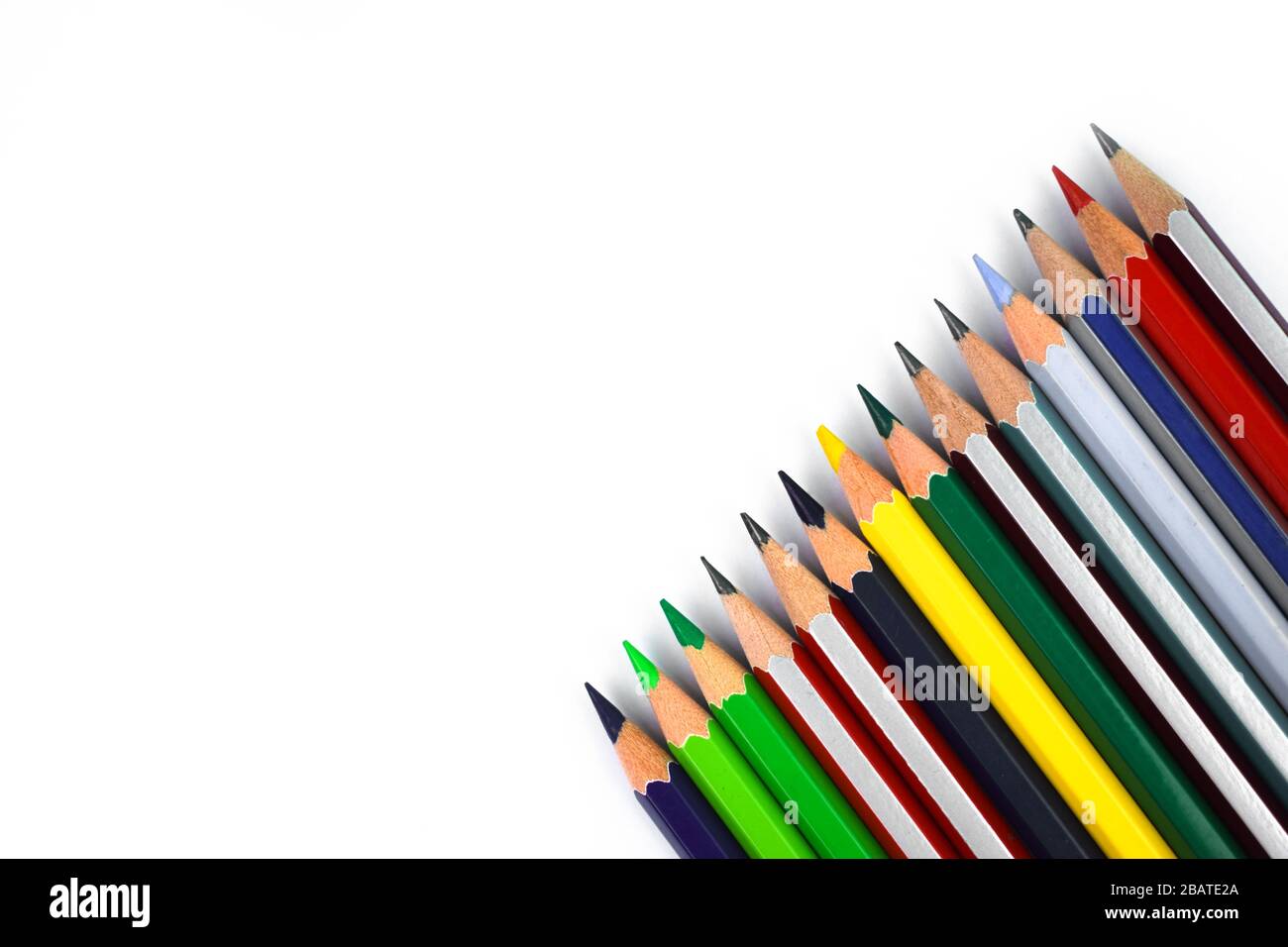 Row of some different colored wood pencil crayons before a empty white ...